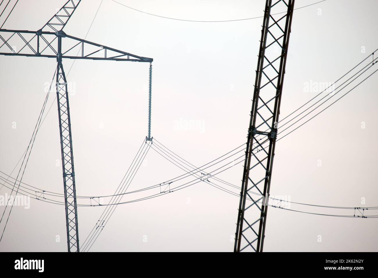 High voltage tower with electric power lines divided by safe guard ...