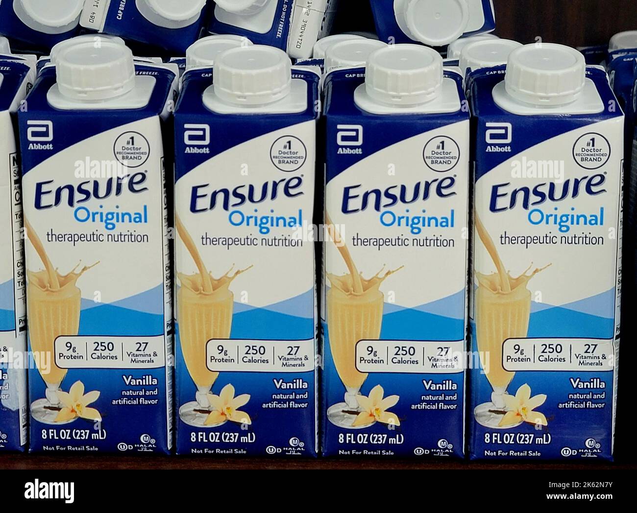 A row of plastic bottles of Ensure High Protein therapeutic nutrition ...