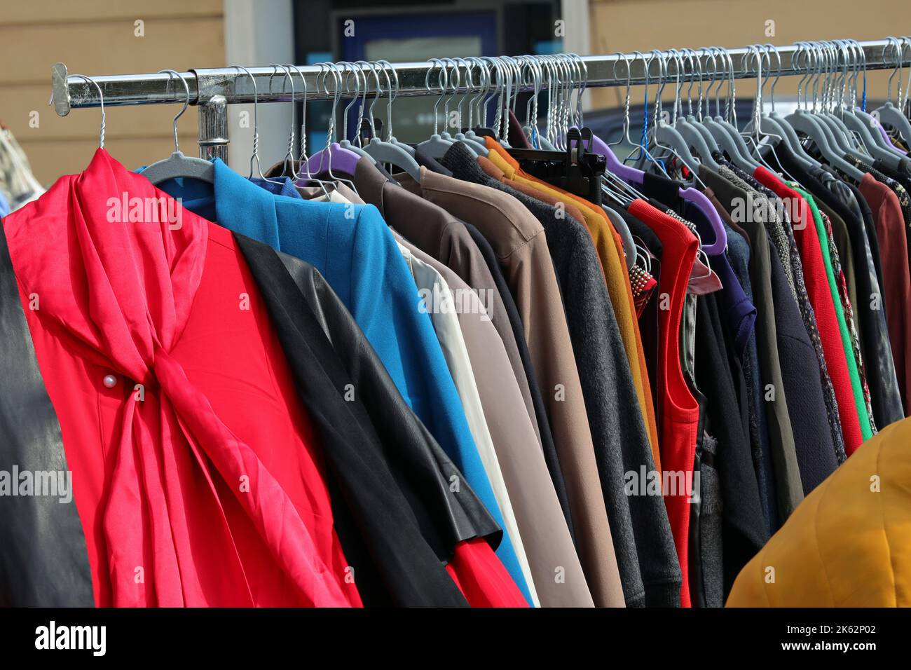 vintage used clothes and new dresses in the stall at the flea market ...