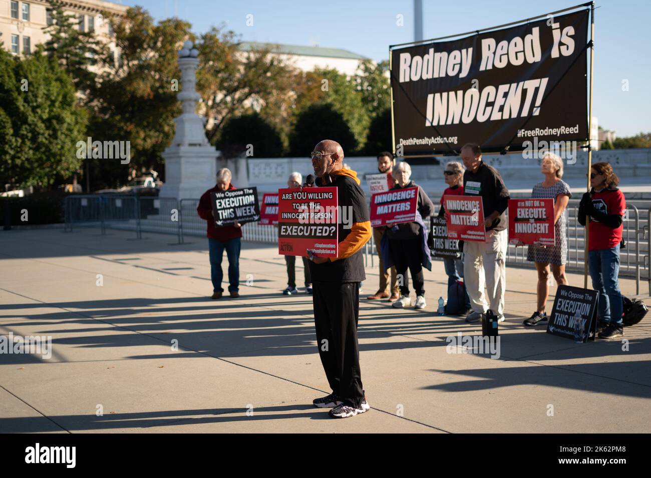 A demonstrator holding a placard speaks to protest against the death ...