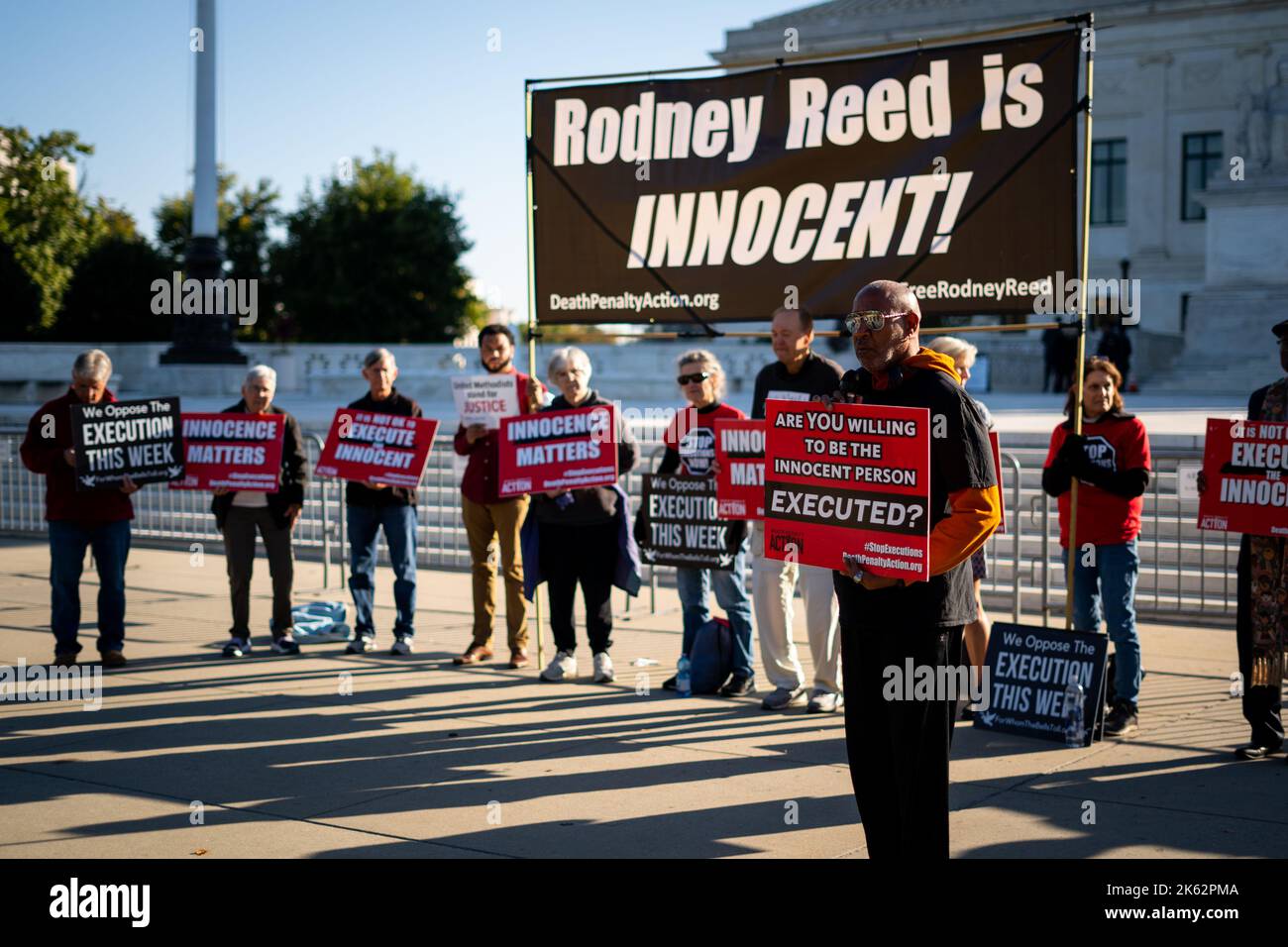 A demonstrator holding a placard speaks to protest against the death ...