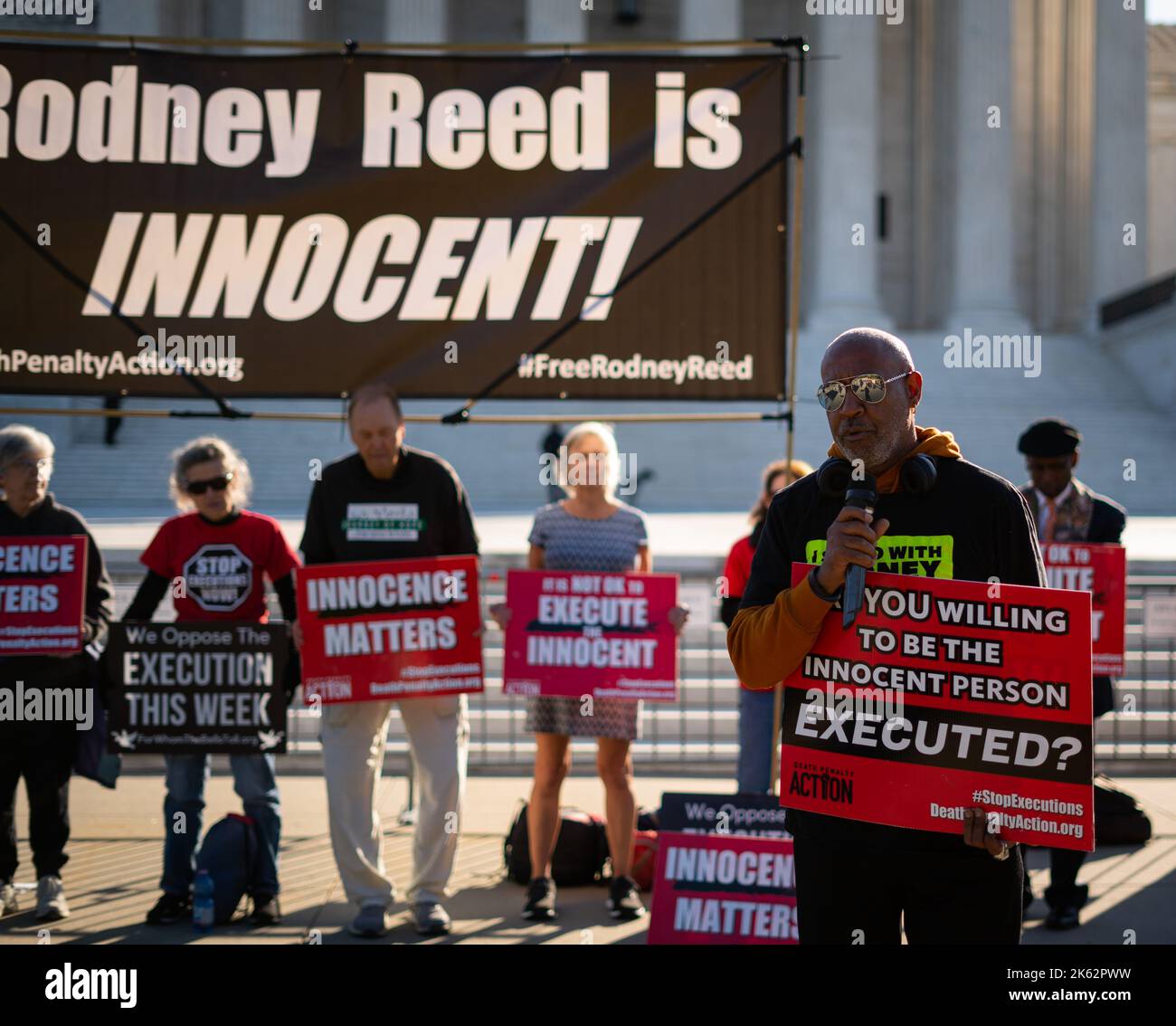 A demonstrator holding a placard speaks to protest against the death ...