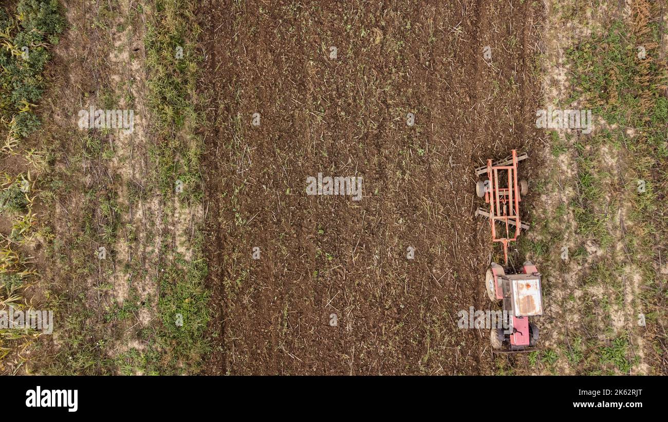 Tractor works the field. Photo from drone Stock Photo - Alamy