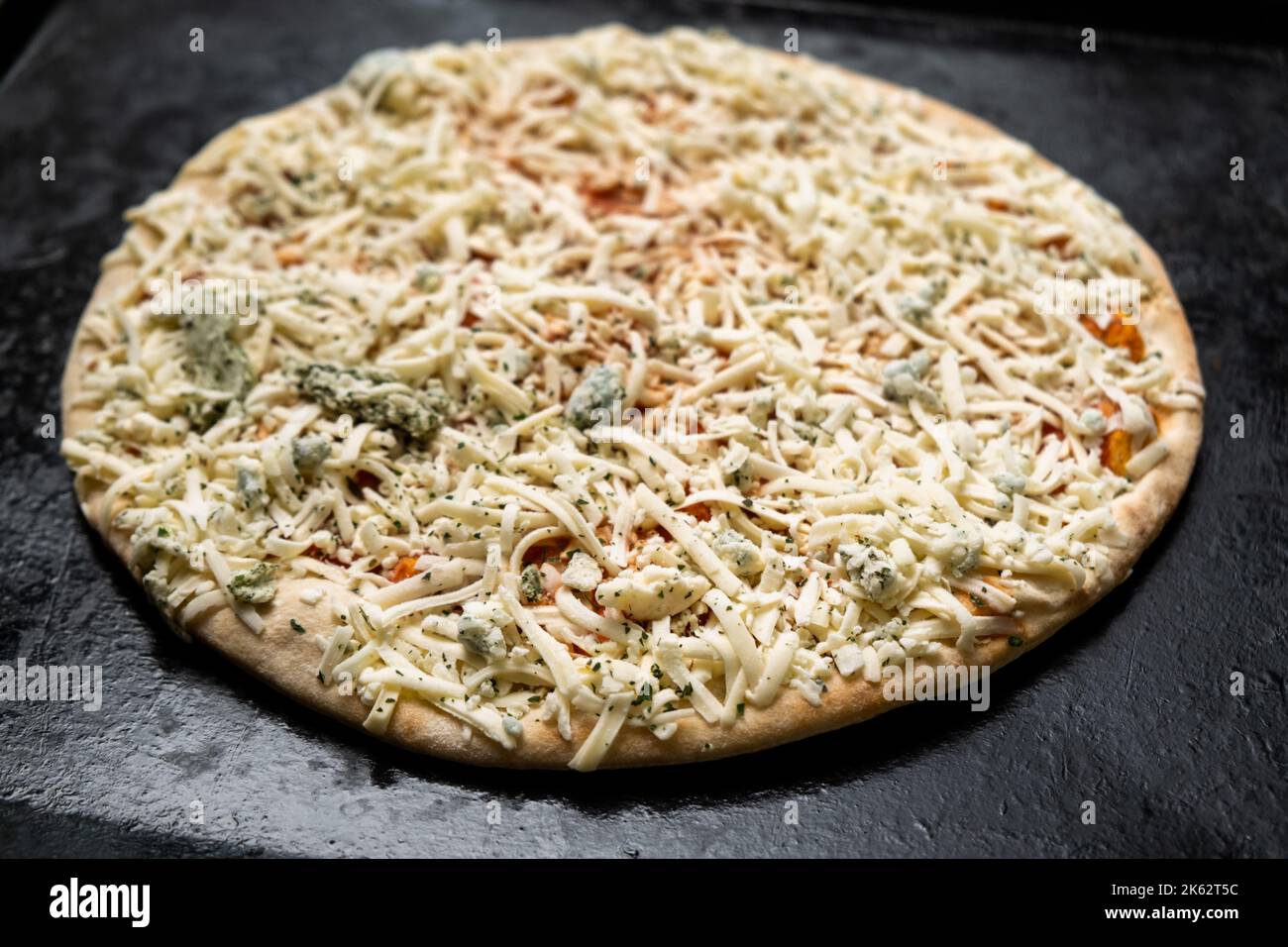 Frozen pizza in plastic wrap. Semifinished Stock Photo - Alamy