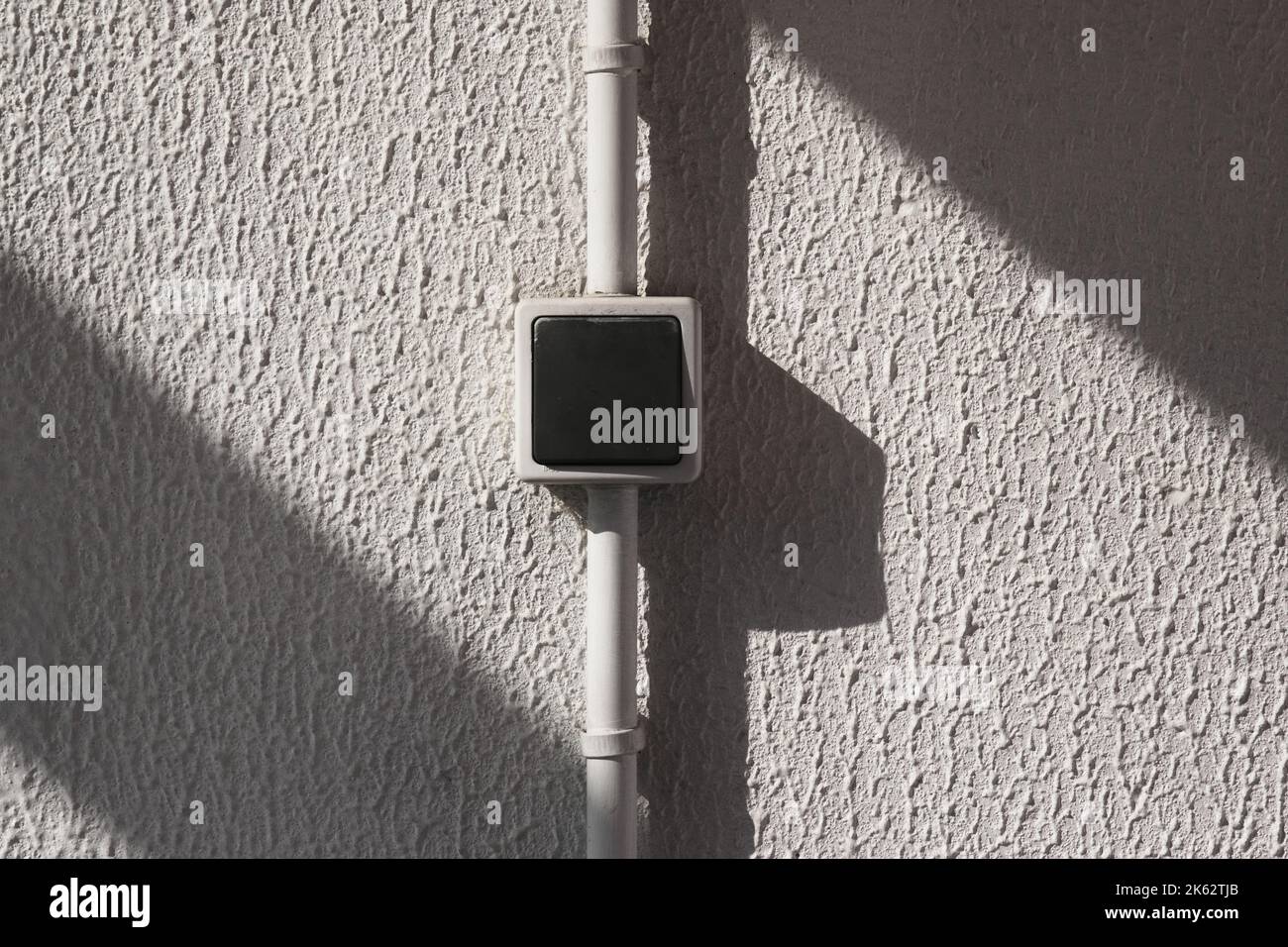 Simple electric switch on the white grungy wall, power toggle, flat ...