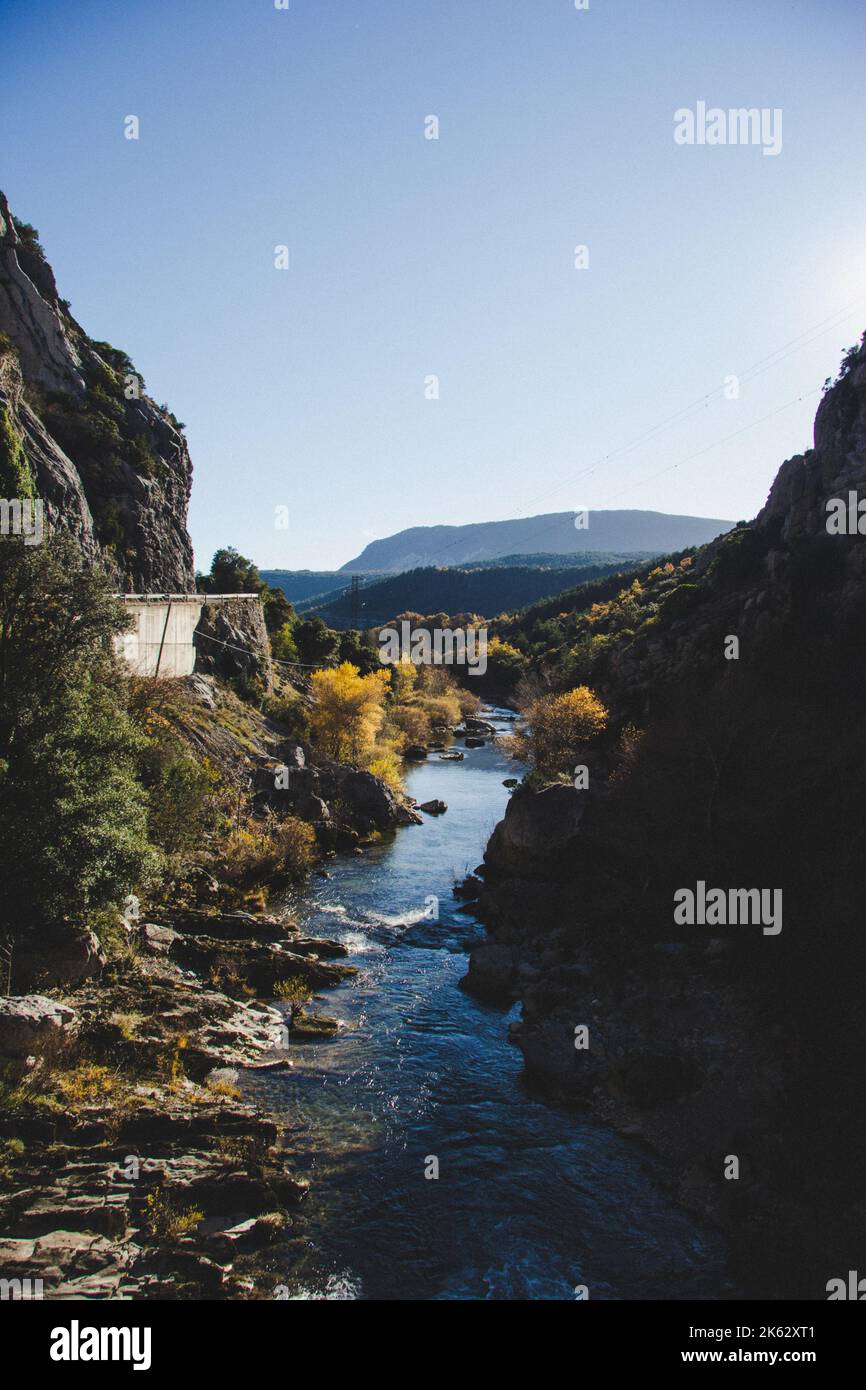 A vertical shot of a river stream passing through the Roncal Valley in ...