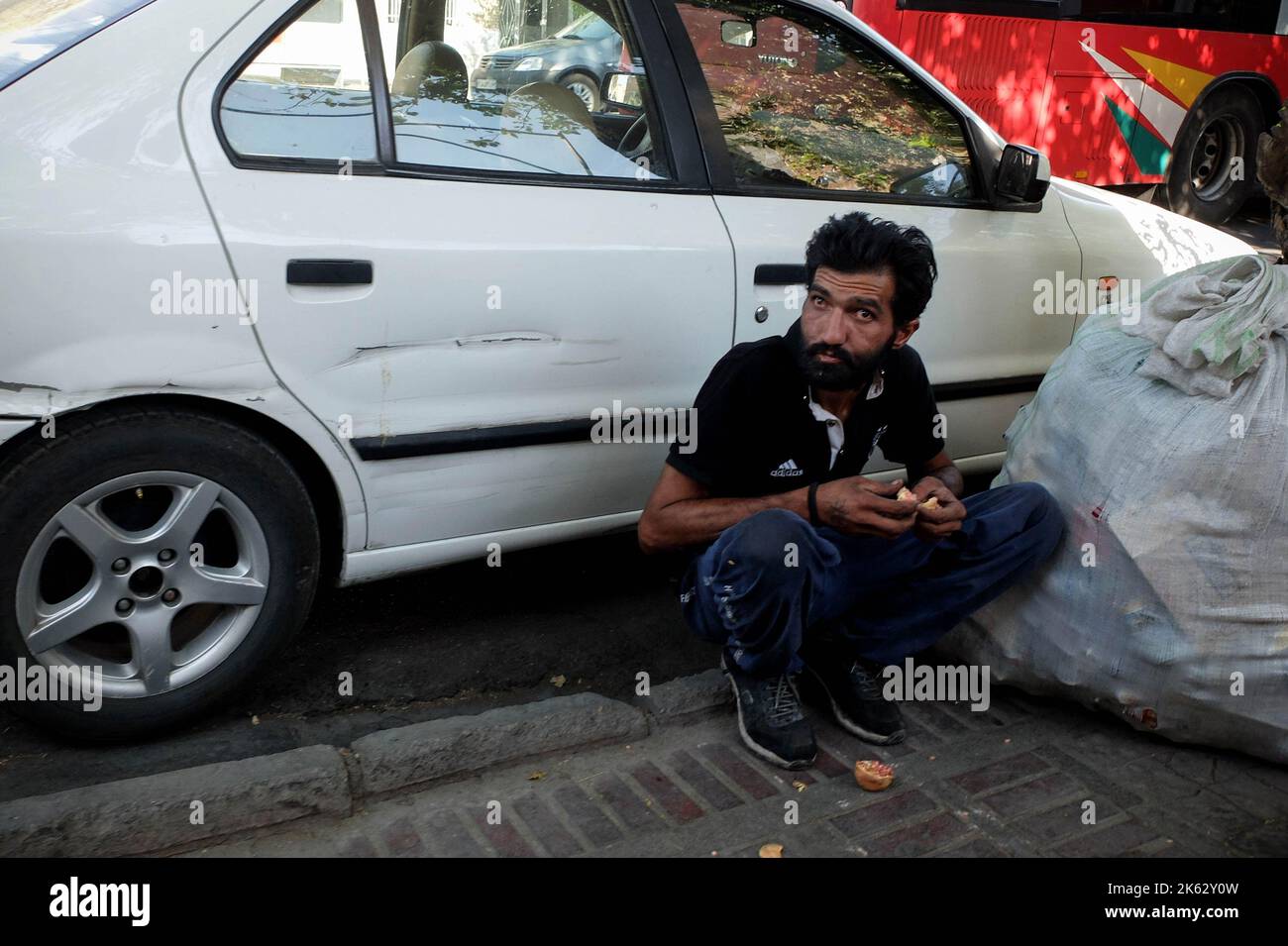Shiraz, Fars, Iran. 9th Oct, 2022. An Iranian homeless man sits near a ...