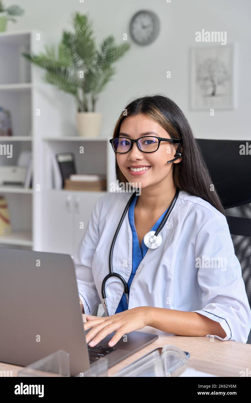 Portrait of successful asian young female doctor at modern workplace ...