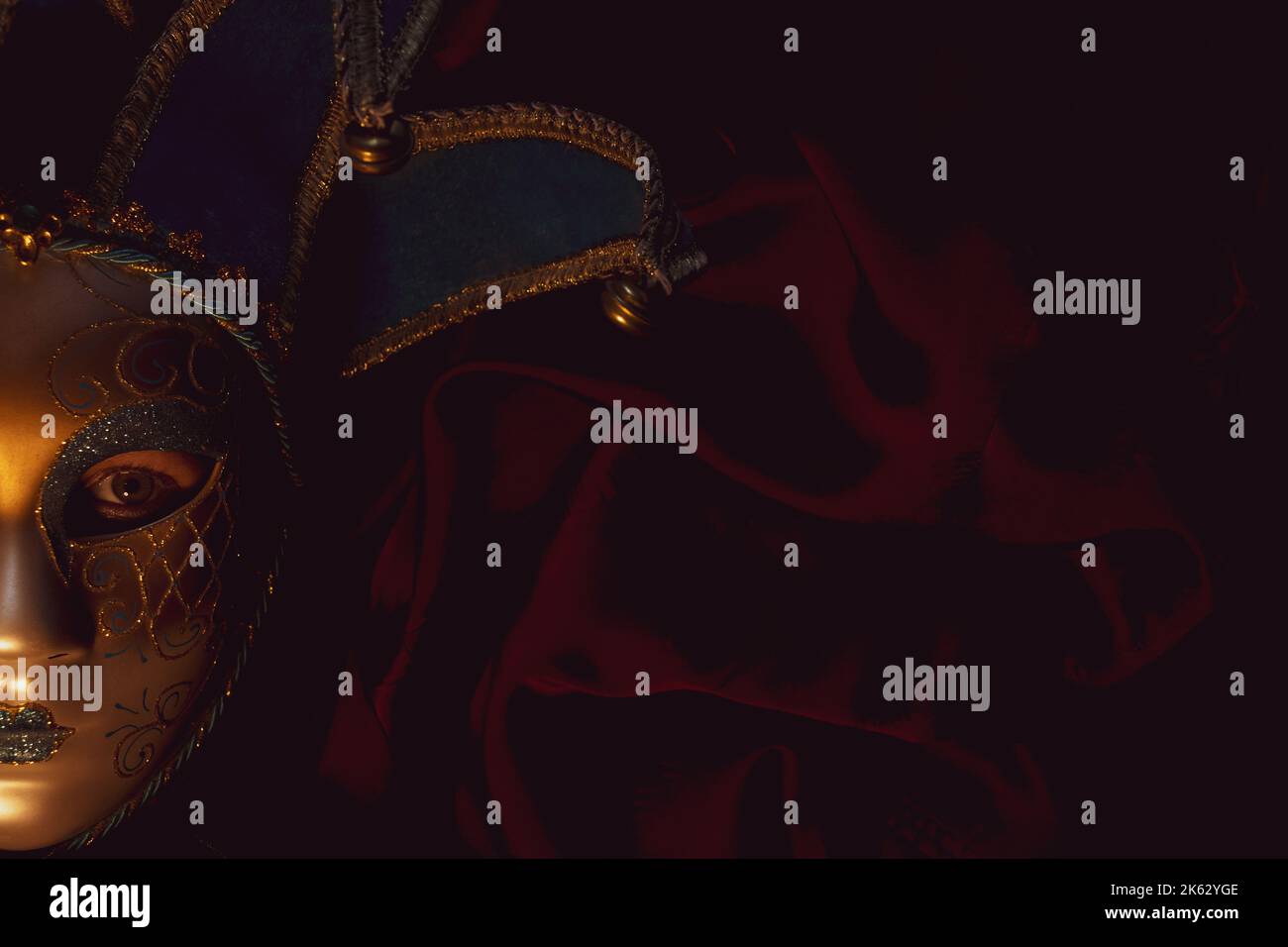 Face of a girl in a Venetian carnival mask in the dark, masquerade and ...