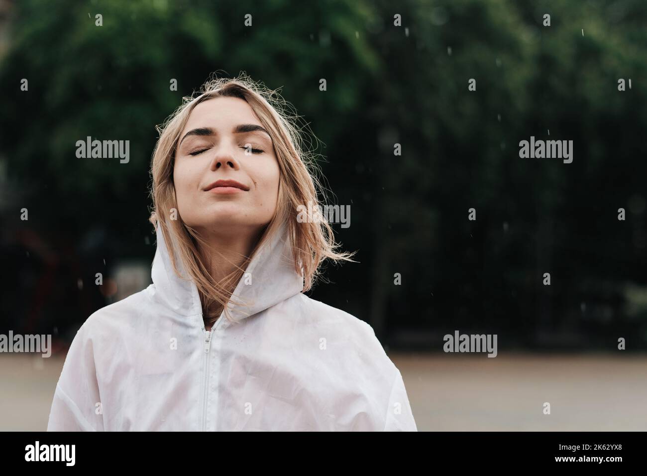 Close Up Portrait of Young Woman Wearing Raincoat While Standing on the ...