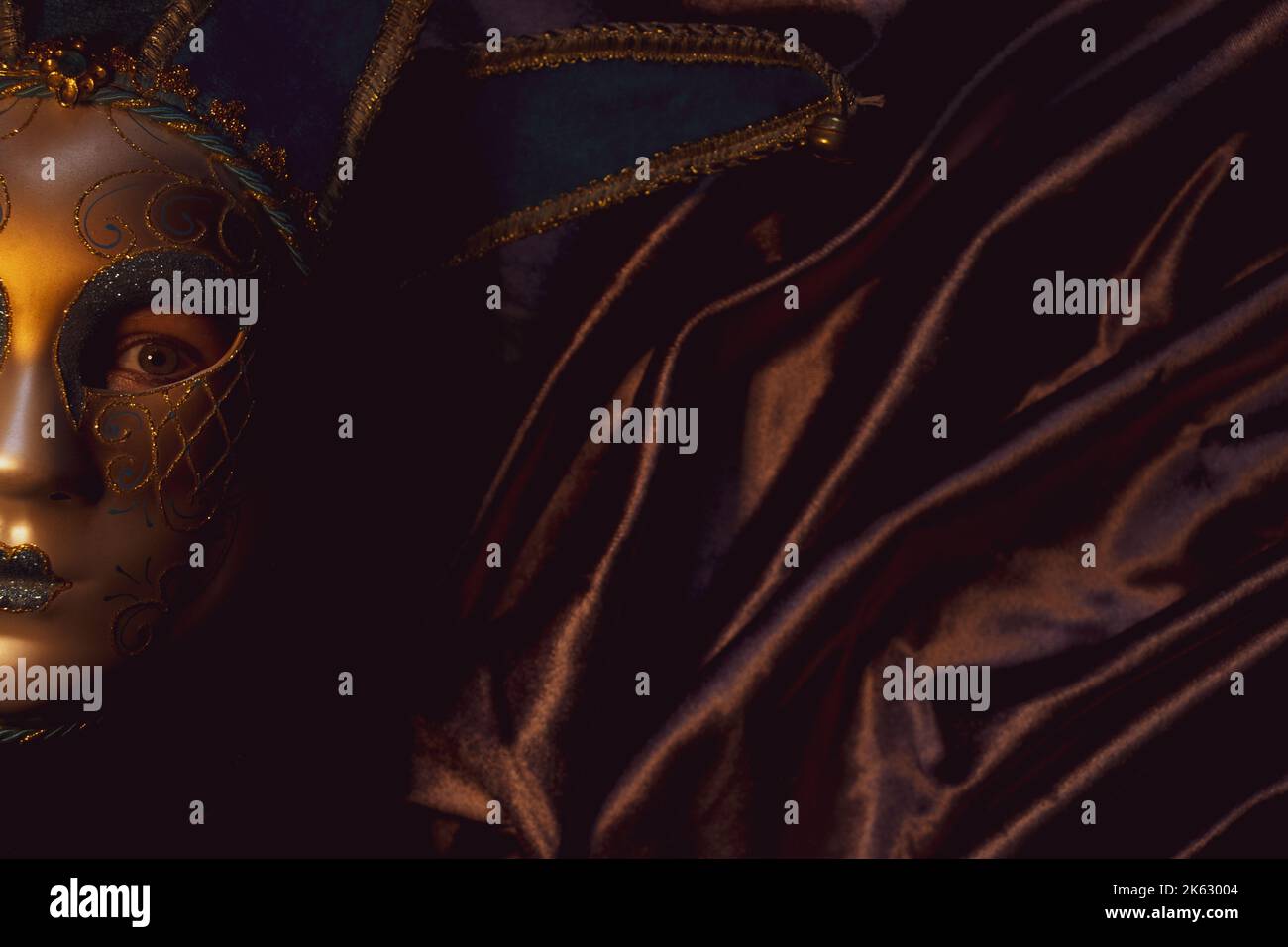 Face of a girl in a Venetian carnival mask in the dark, masquerade and ...