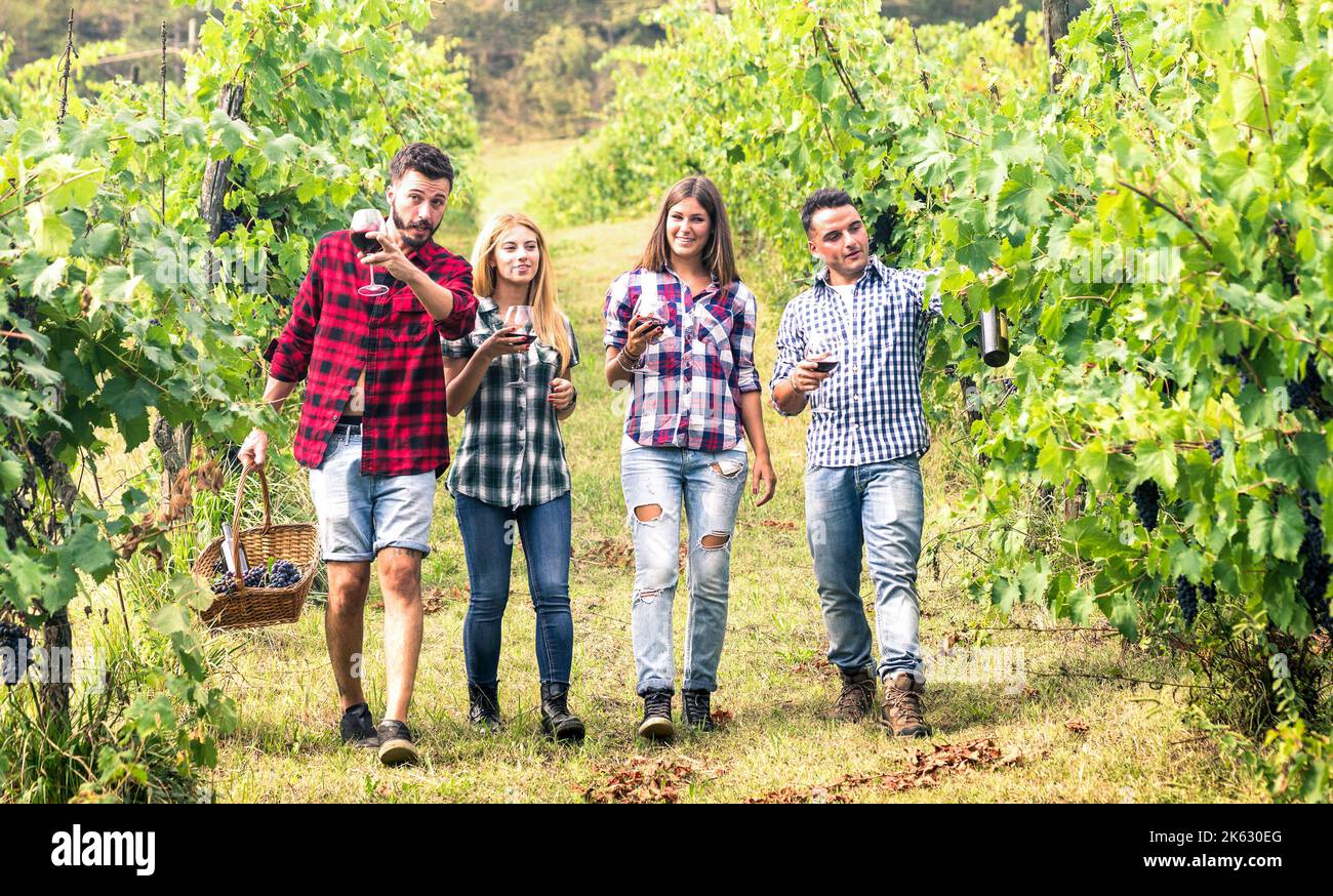 Young friends having fun walking at winery vineyard outdoors ...