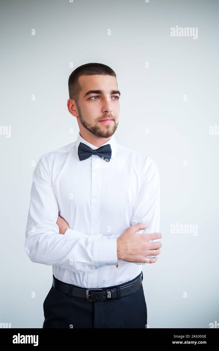 Young male businessman dressed in a white shirt with a short beard ...