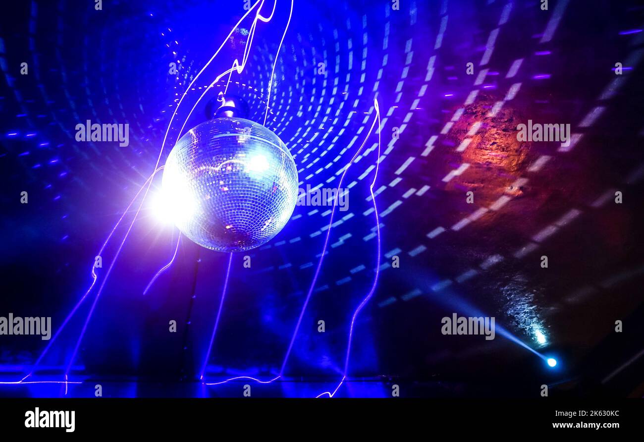 Disco ball laser show in modern disco party night club with bright ...
