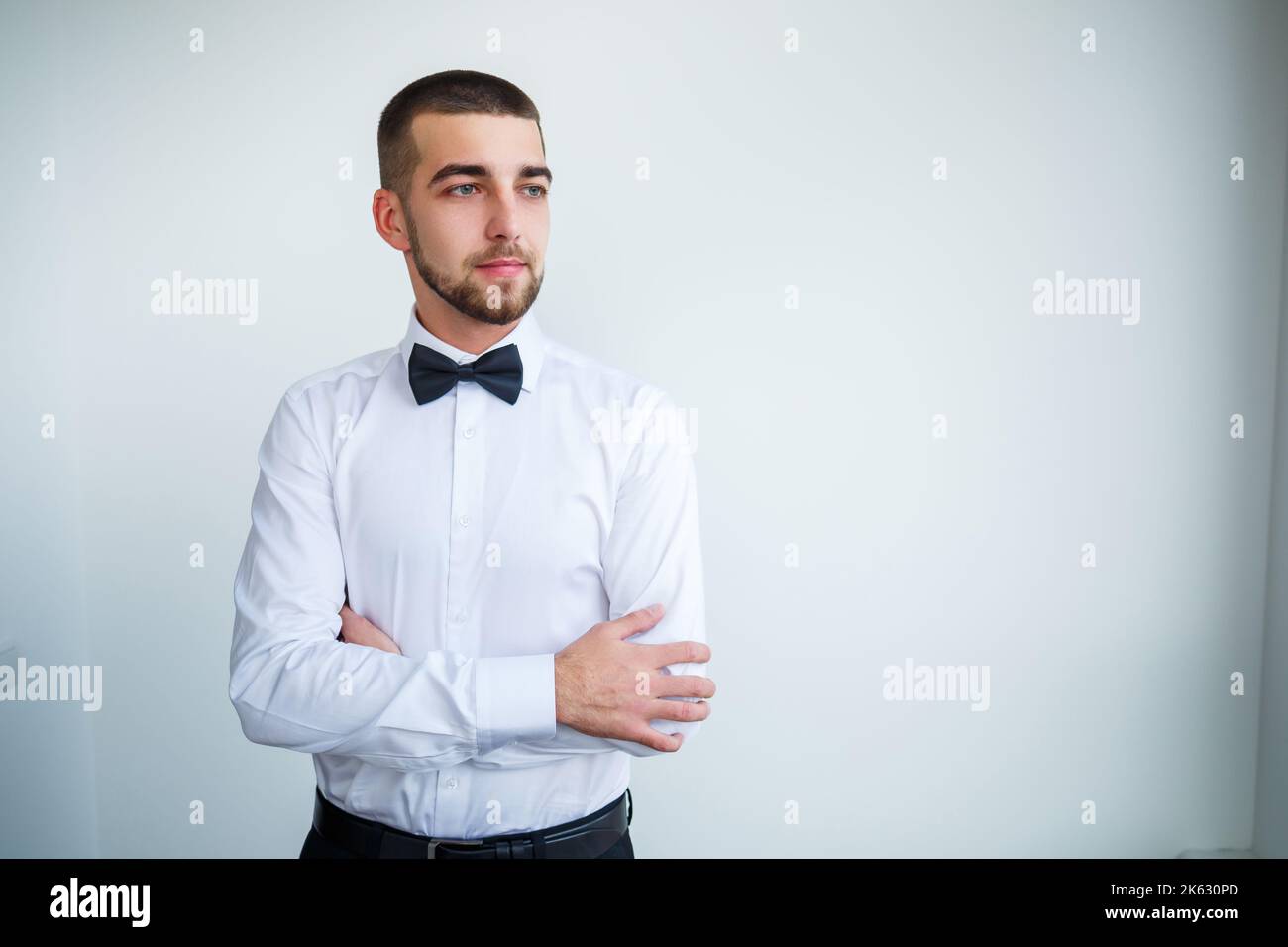 Young male businessman dressed in a white shirt with a short beard ...