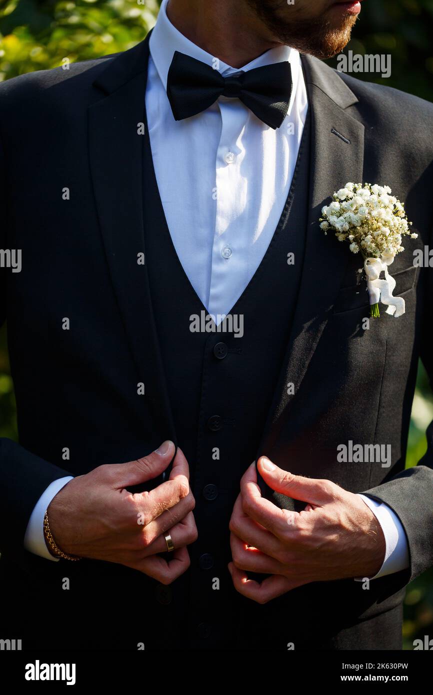 Stylish man groom buttoning a button on his jacket Stock Photo - Alamy