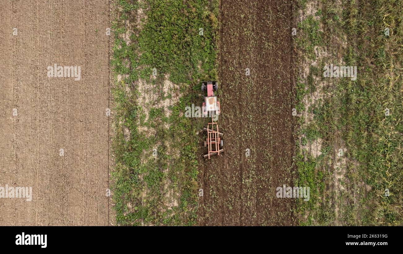 Tractor works the field. Photo from drone Stock Photo - Alamy