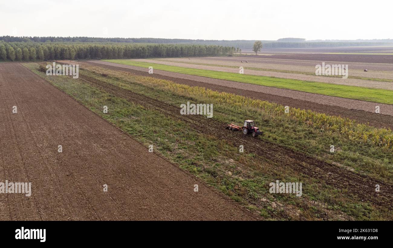Tractor works the field. Photo from drone Stock Photo - Alamy
