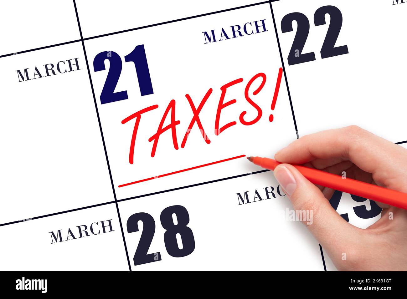 21st day of March. Hand drawing red line and writing the text Taxes on ...