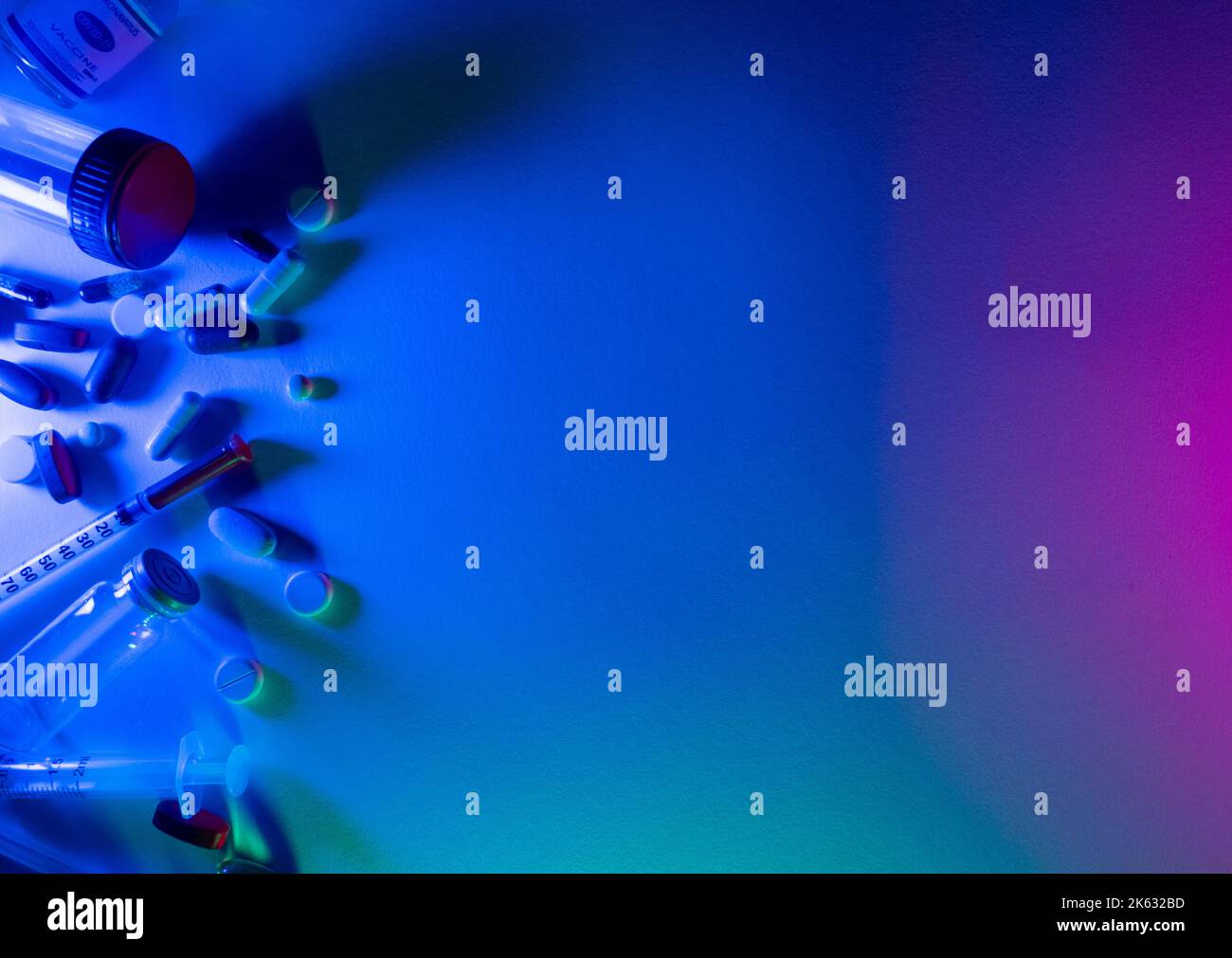 covid-19 medication neon background syringe pills Stock Photo - Alamy
