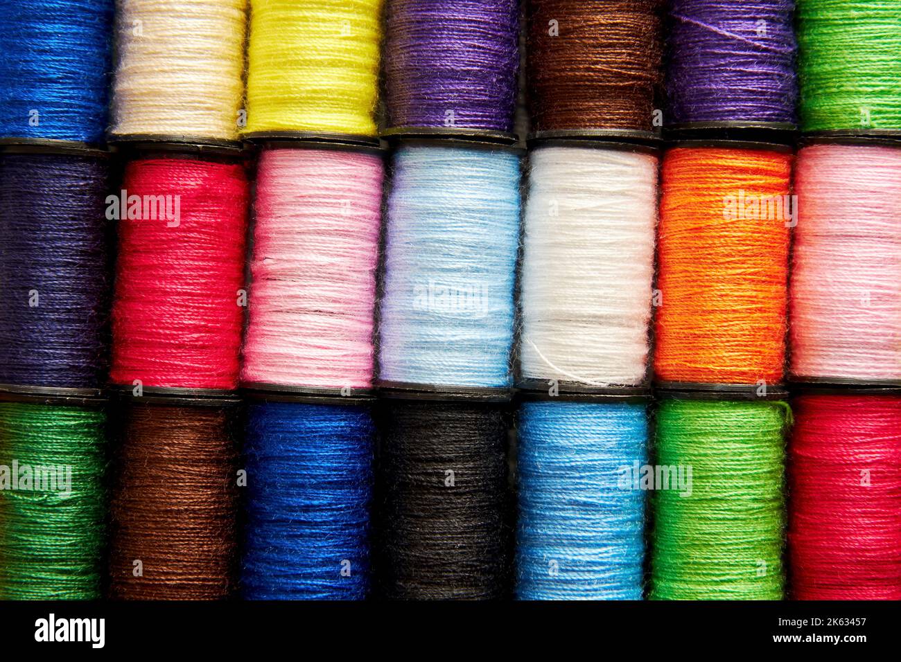 Background pattern of set of colorful rainbow sew thread spools on the ...