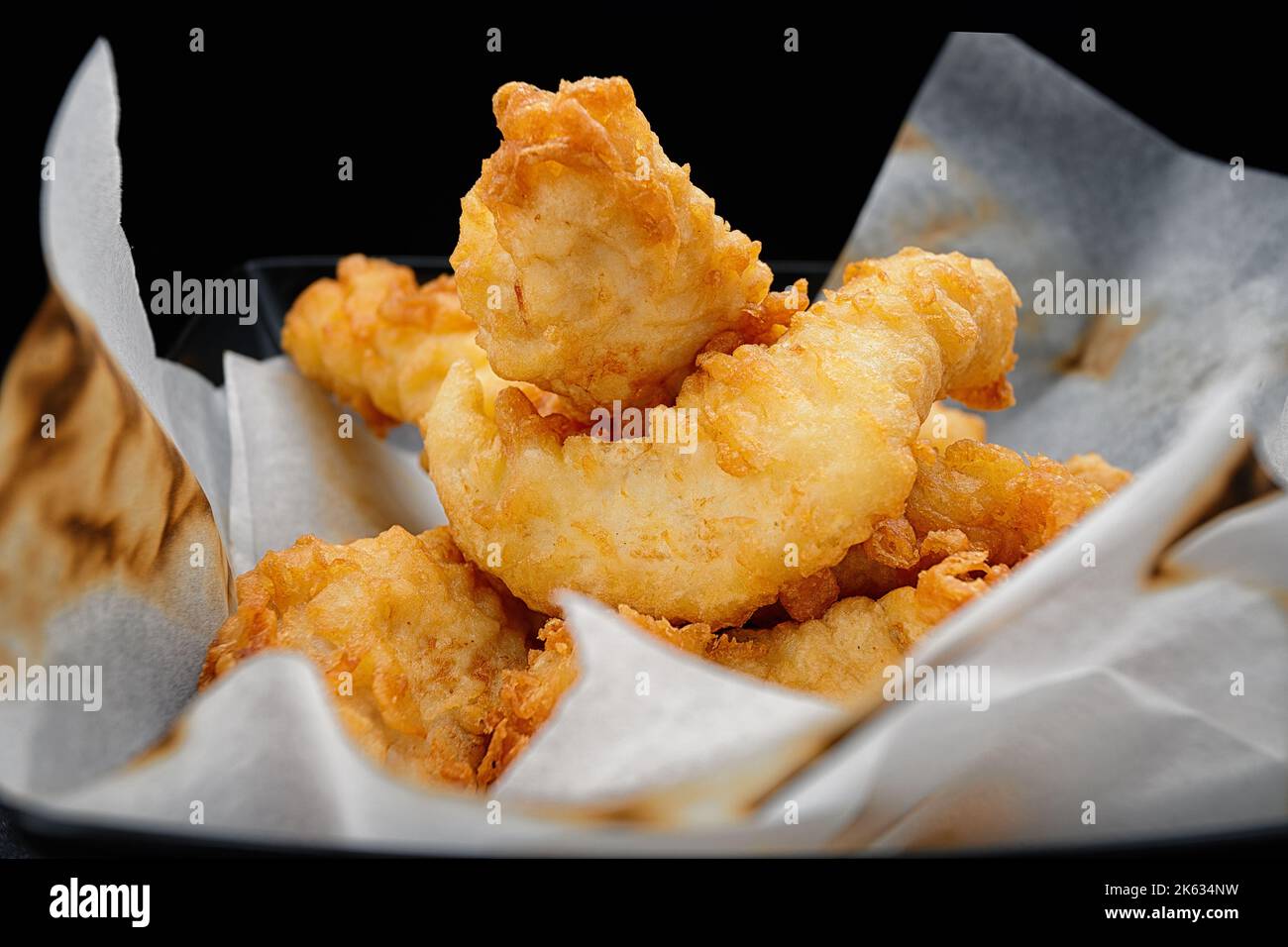 Chicken nuggets on paper, on dark concrete Stock Photo - Alamy