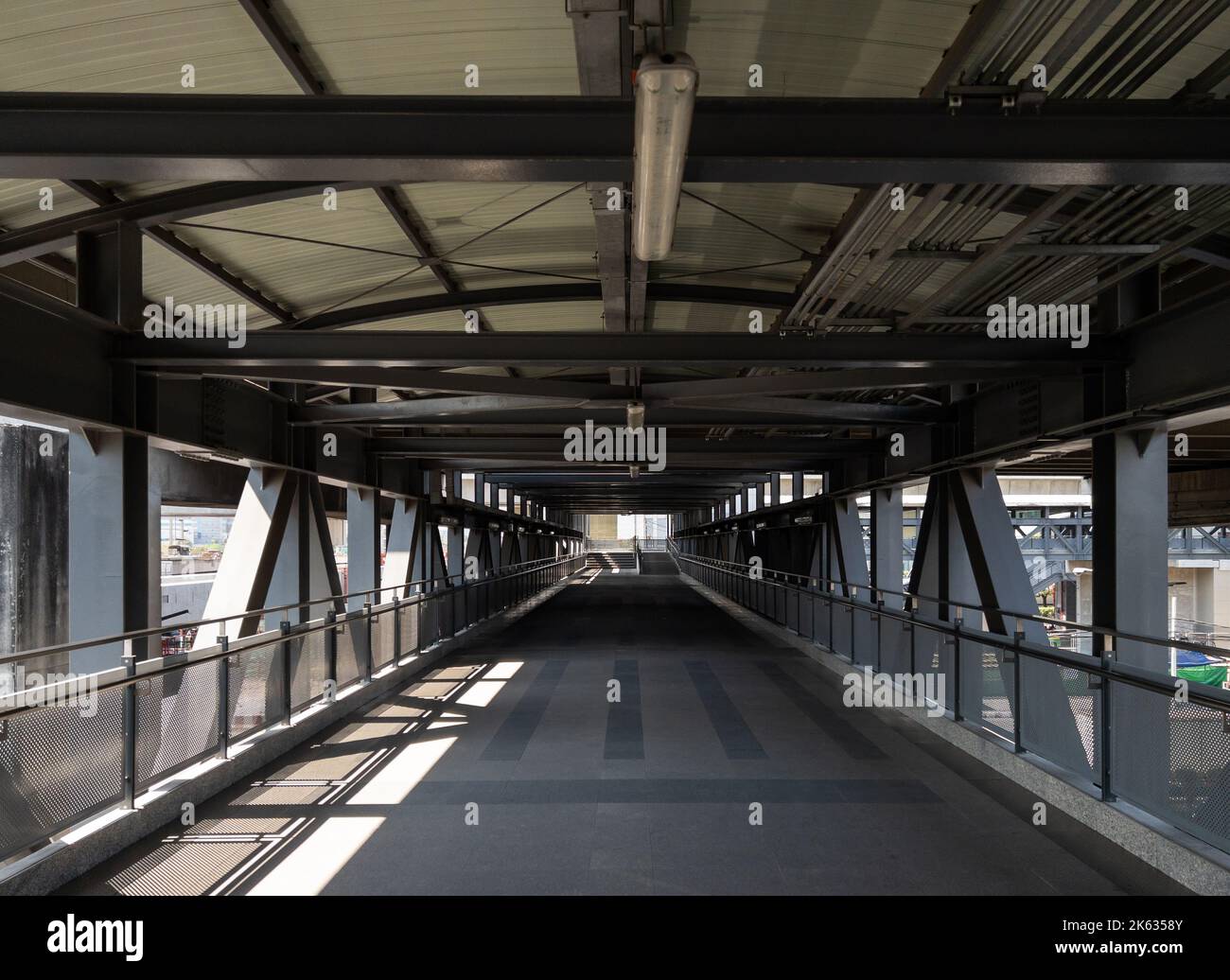 The lonely walkway of the metal frame bridge from the suburban MRT ...