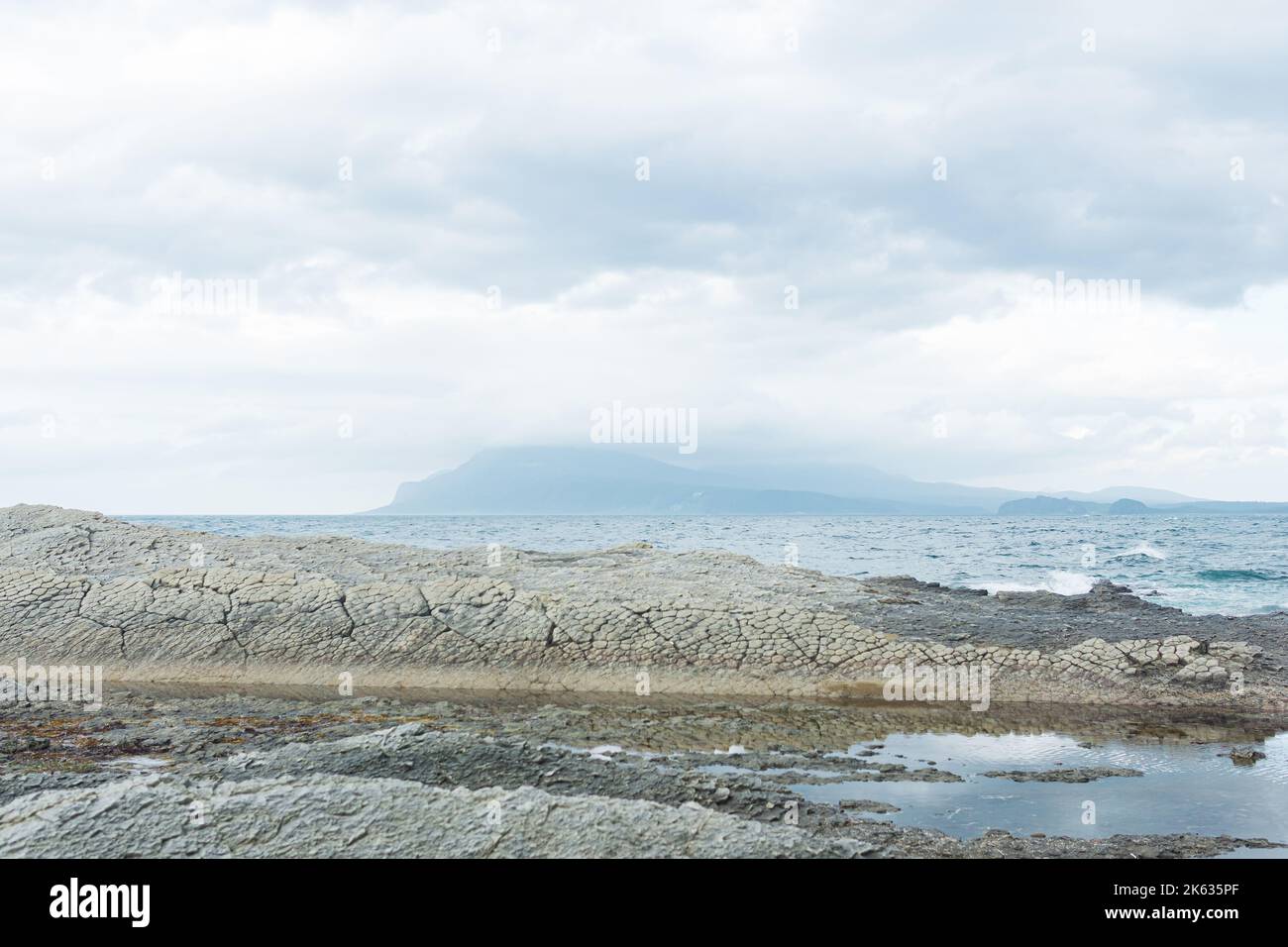 rocky seashore made of columnar granite, hardened lava, resembling ...