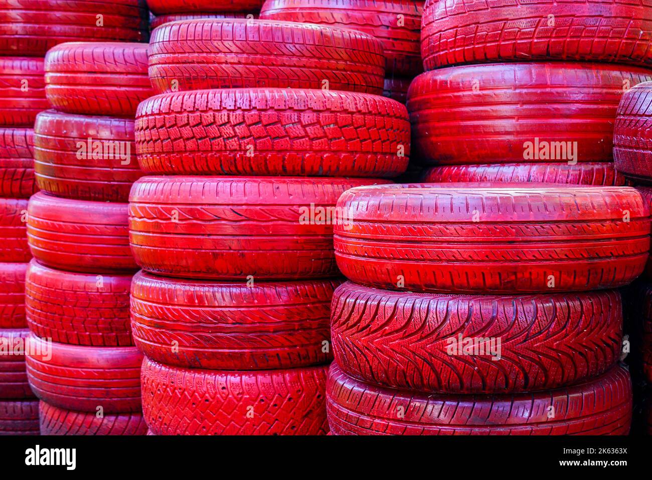 pile of used tires painted red, background of red tires Stock Photo - Alamy