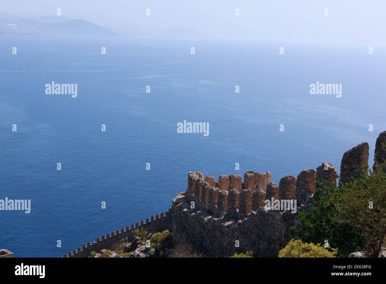 the old wall of the ancient castle is visible against the blue sea ...