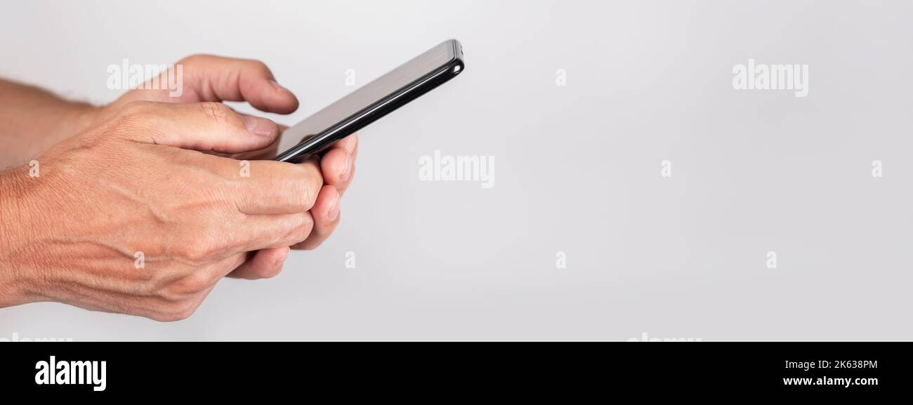 Hand holding mobile phone, smartphone, side view. Banner with ...