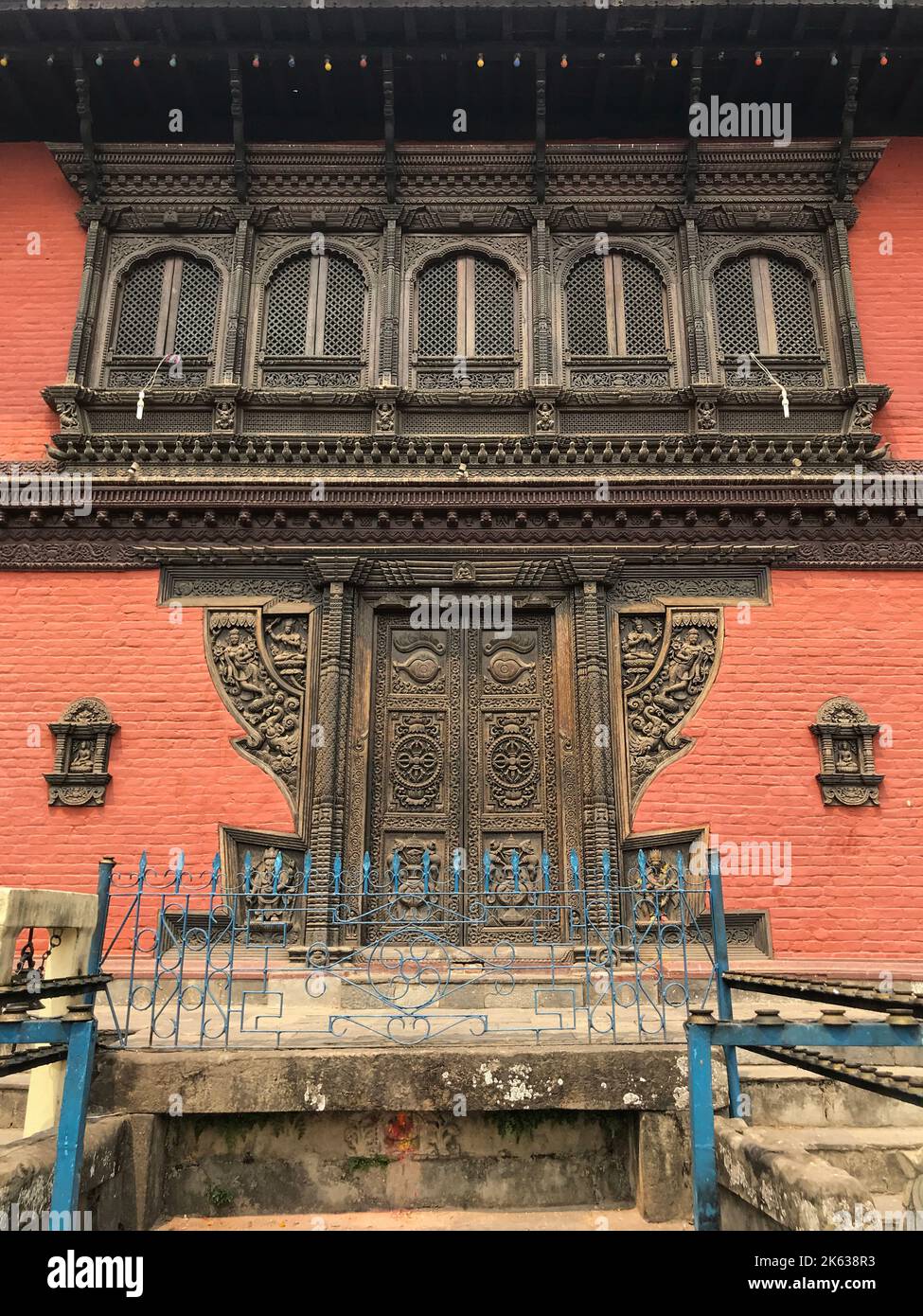 A vertical shot of the Kumari Ghar temple with intricately carved doors ...