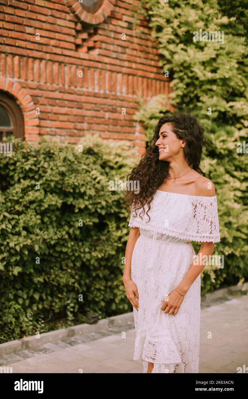 Young curly hair woman in the park Stock Photo - Alamy