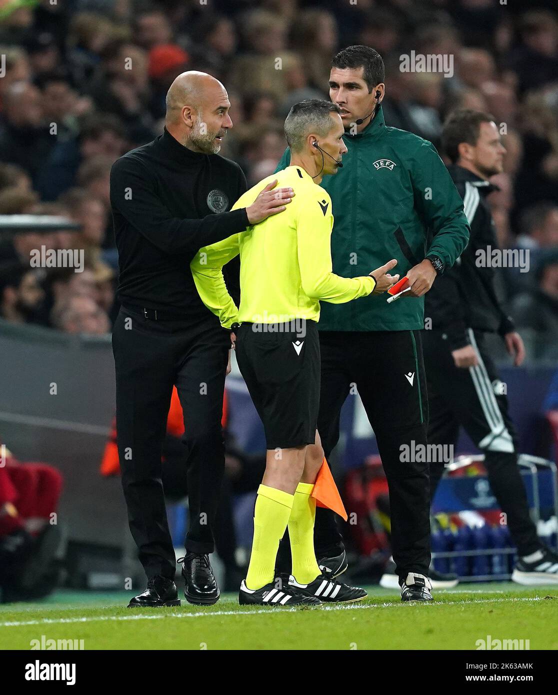 Manchester City manager Pep Guardiola (left) speaks with assistant ...