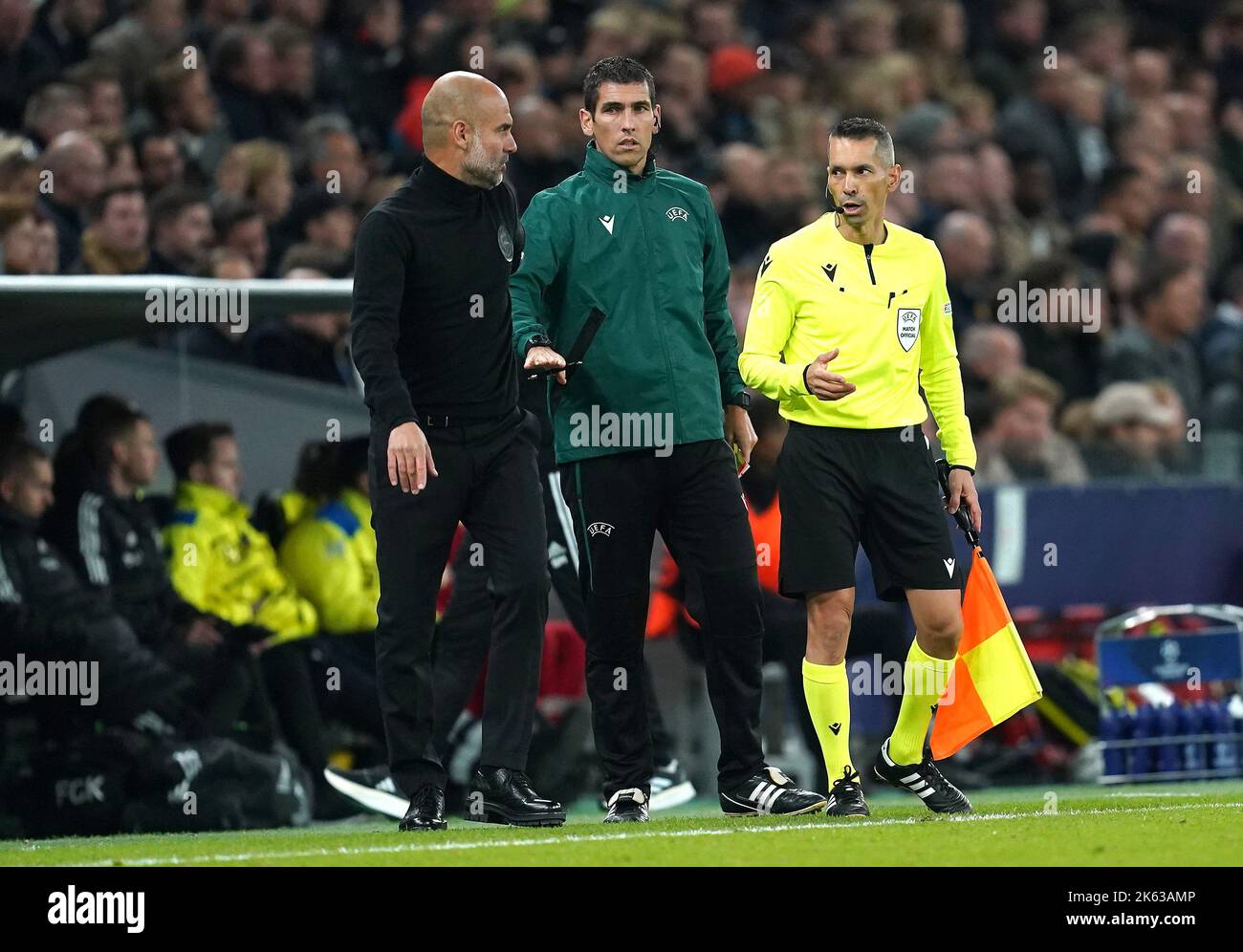 Manchester City manager Pep Guardiola (left) speaks with assistant ...