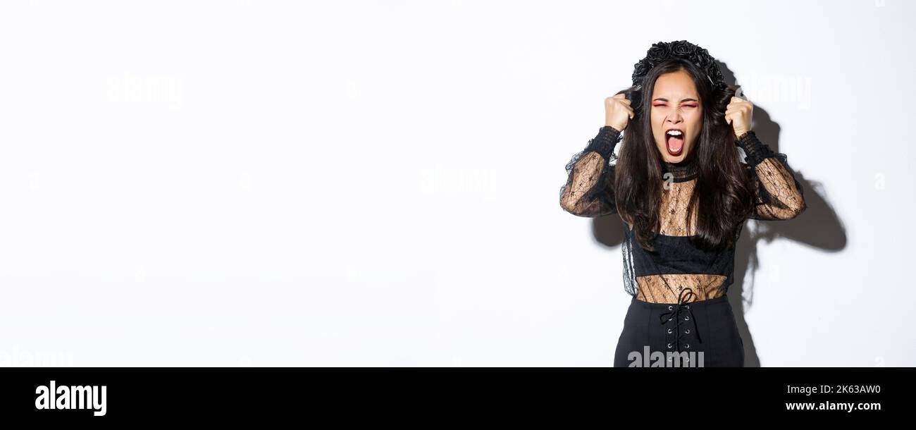 Image of angry distressed asian woman screaming and ripping hair of ...