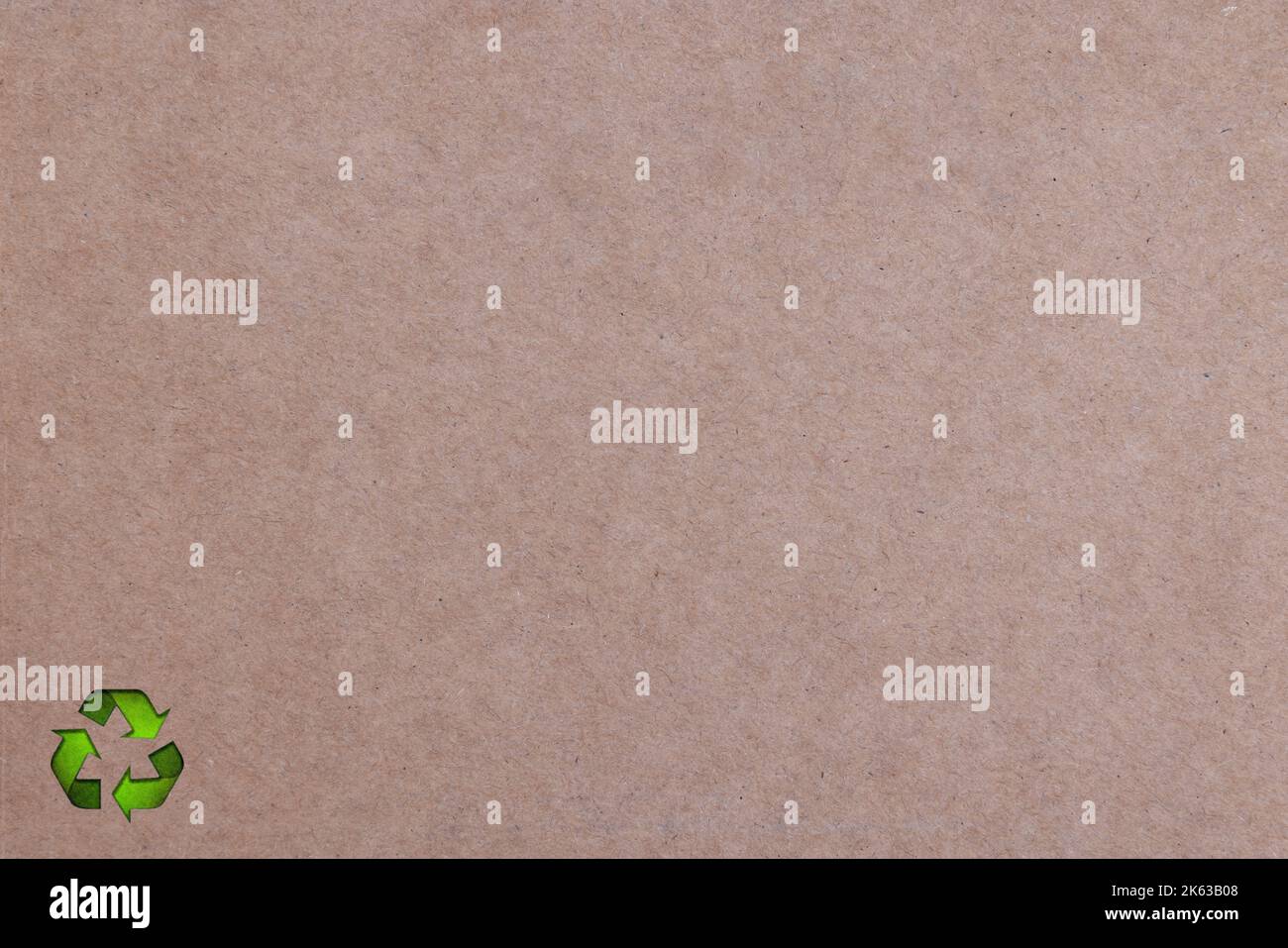 Brown Cardboard with three green arrows going in a triangle, international recycle symbol. Paper ...