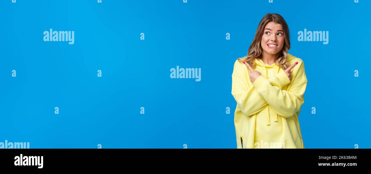 Indecisive and unsure cute blond girl making her choice and have doubts ...