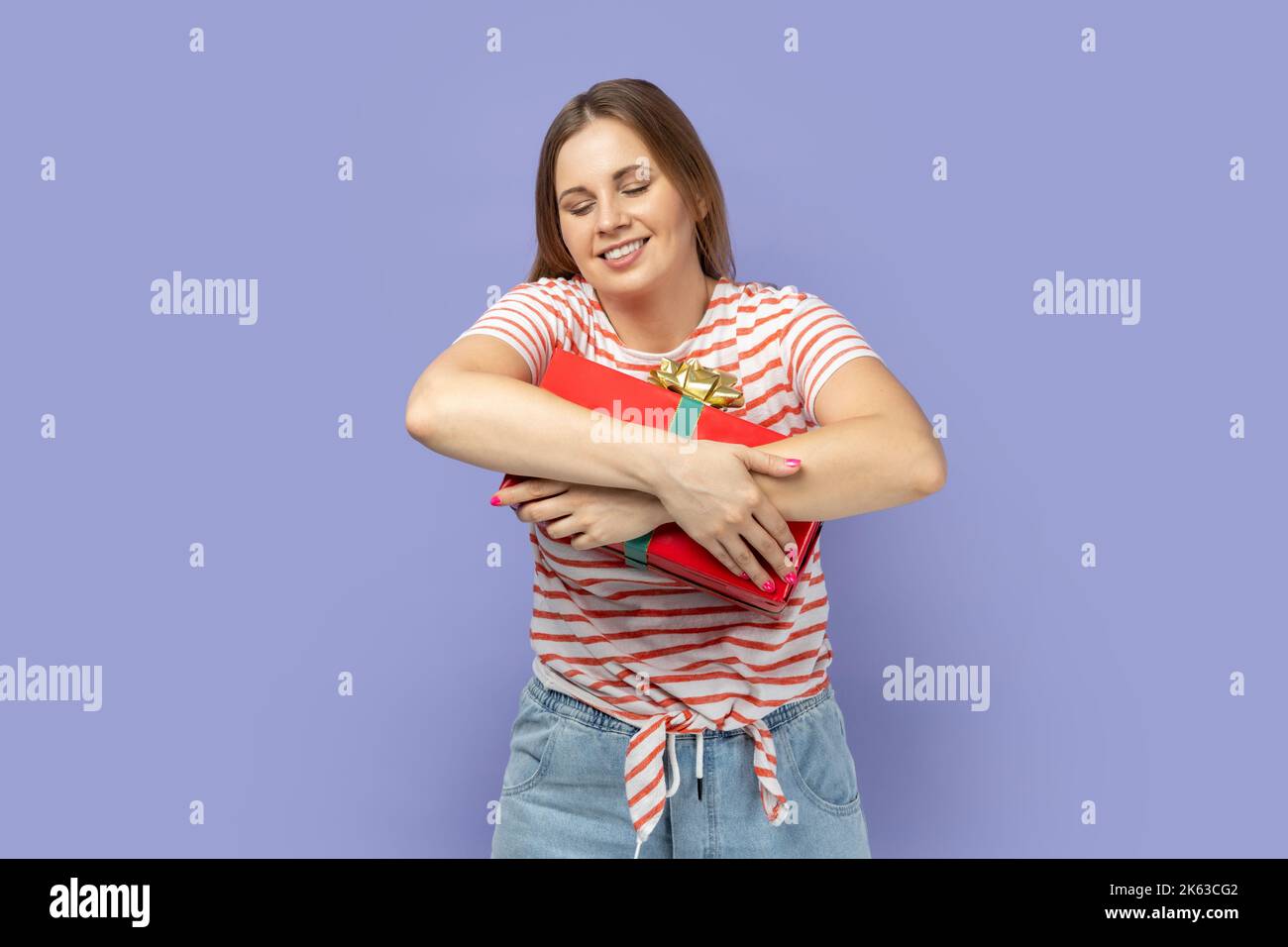 Portrait of pleased positive blond woman wearing striped T-shirt ...