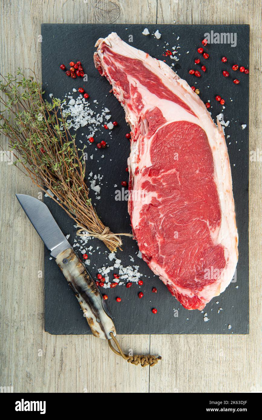 Raw entrecote with spices on the table of the kitchen Stock Photo - Alamy
