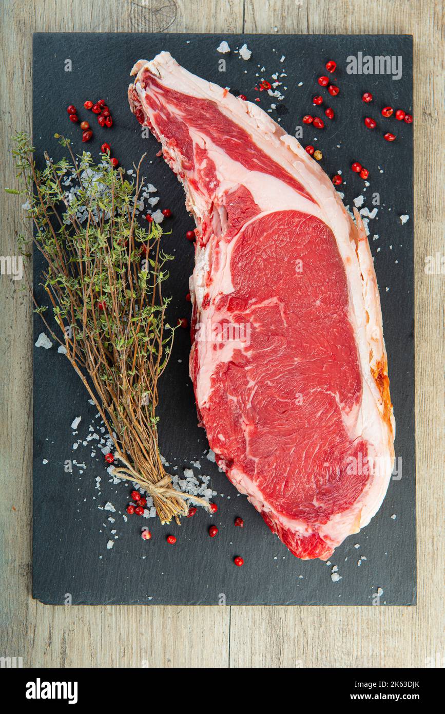Raw entrecote with spices on the table of the kitchen Stock Photo - Alamy
