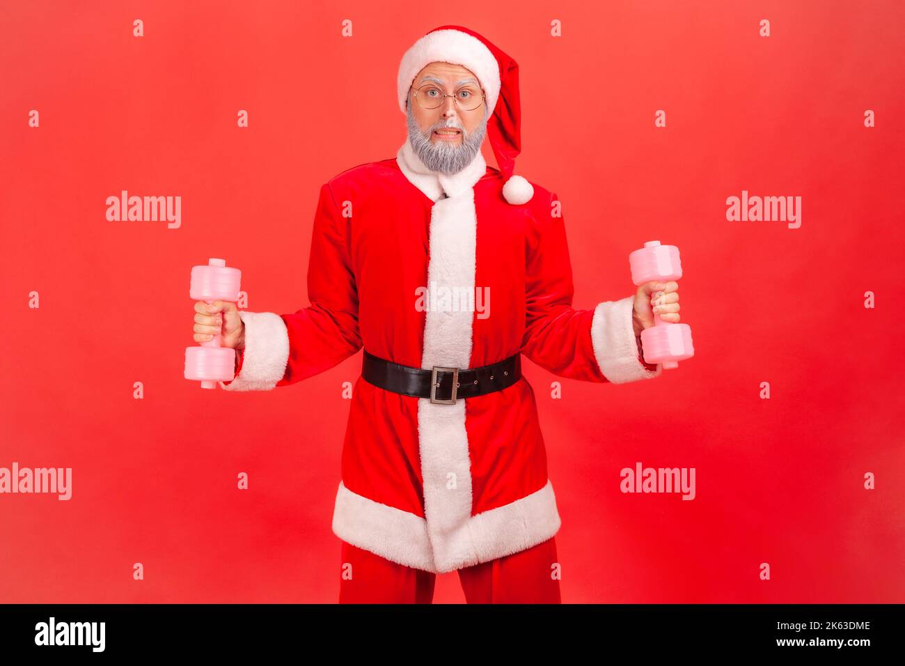 Portrait of strong elderly man with gray beard wearing santa claus ...