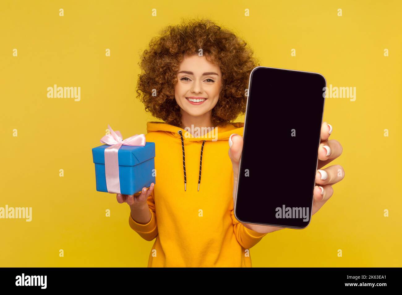 Cute delighted woman with Afro hairstyle wearing casual style hoodie ...