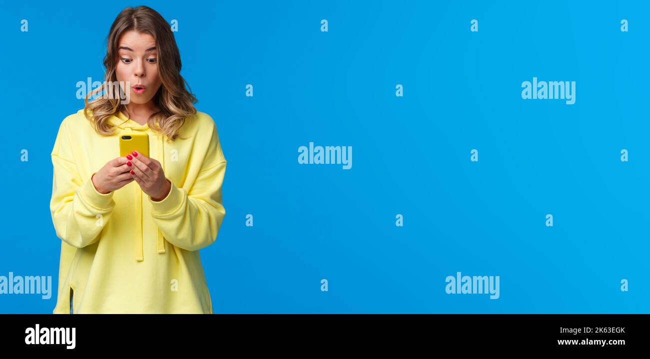 Surprised and intrigued good-looking blond female seeing something ...