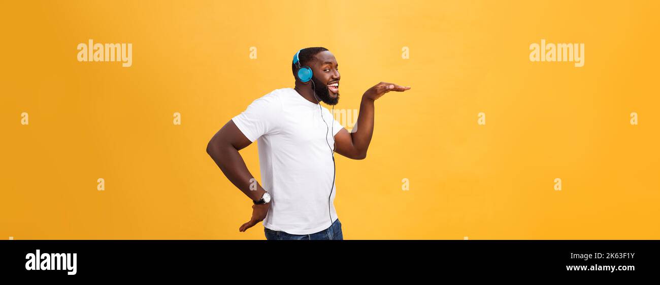 Young African American man wearing headphone and enjoy music dancing ...