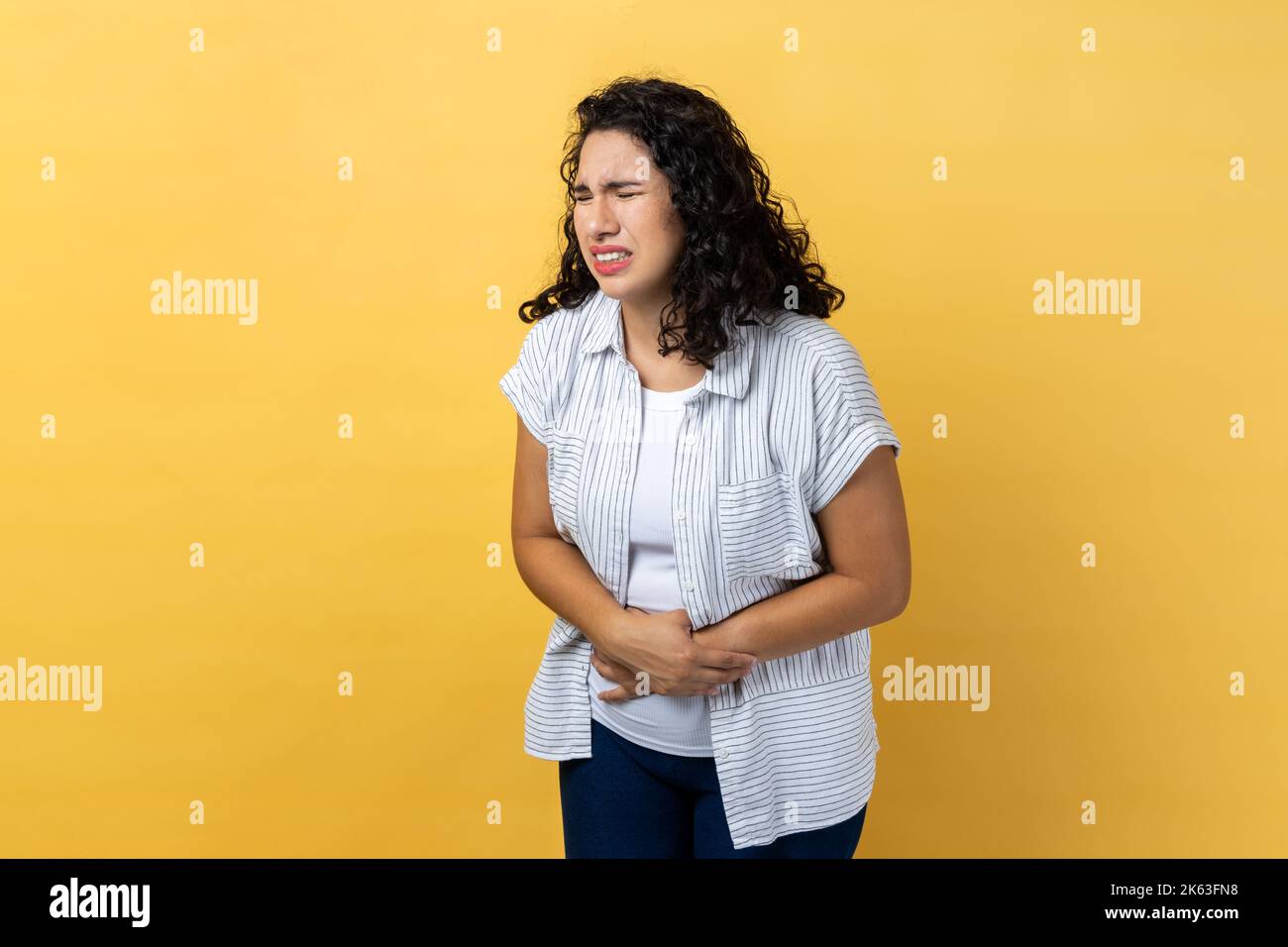 Portrait of unhealthy sick beautiful woman with dark wavy hair standing ...