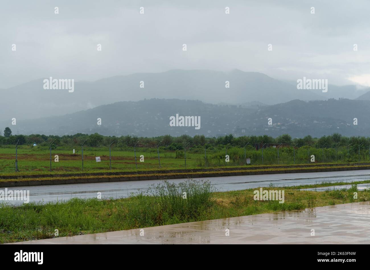 Houses on the slopes of the mountains in rainy weather, in the ...