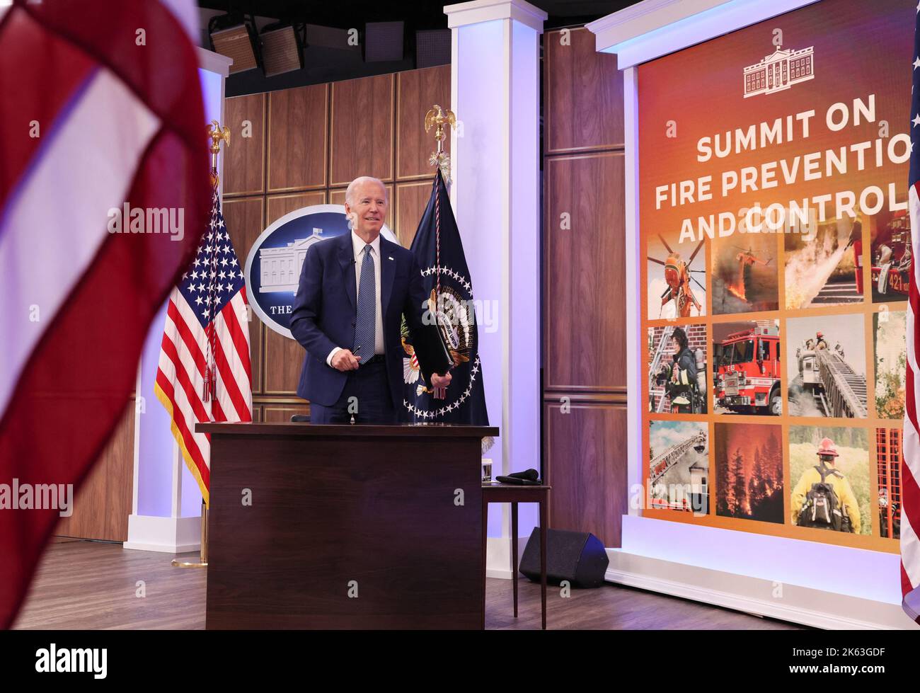 President Joe Biden stands after addressing a virtual audience ...