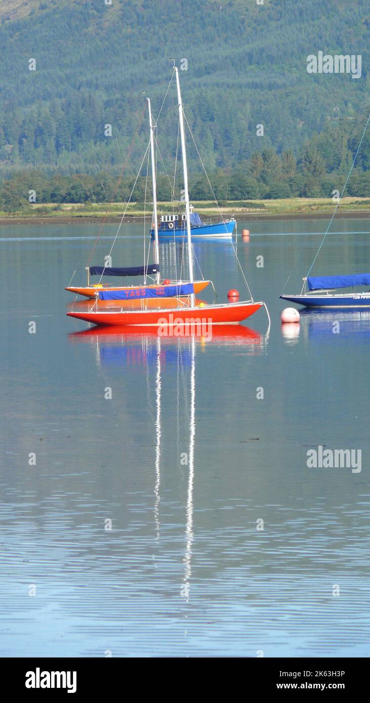 A vertical shot of boats reflecting in Holy Loch in Argyll, Dunoon ...