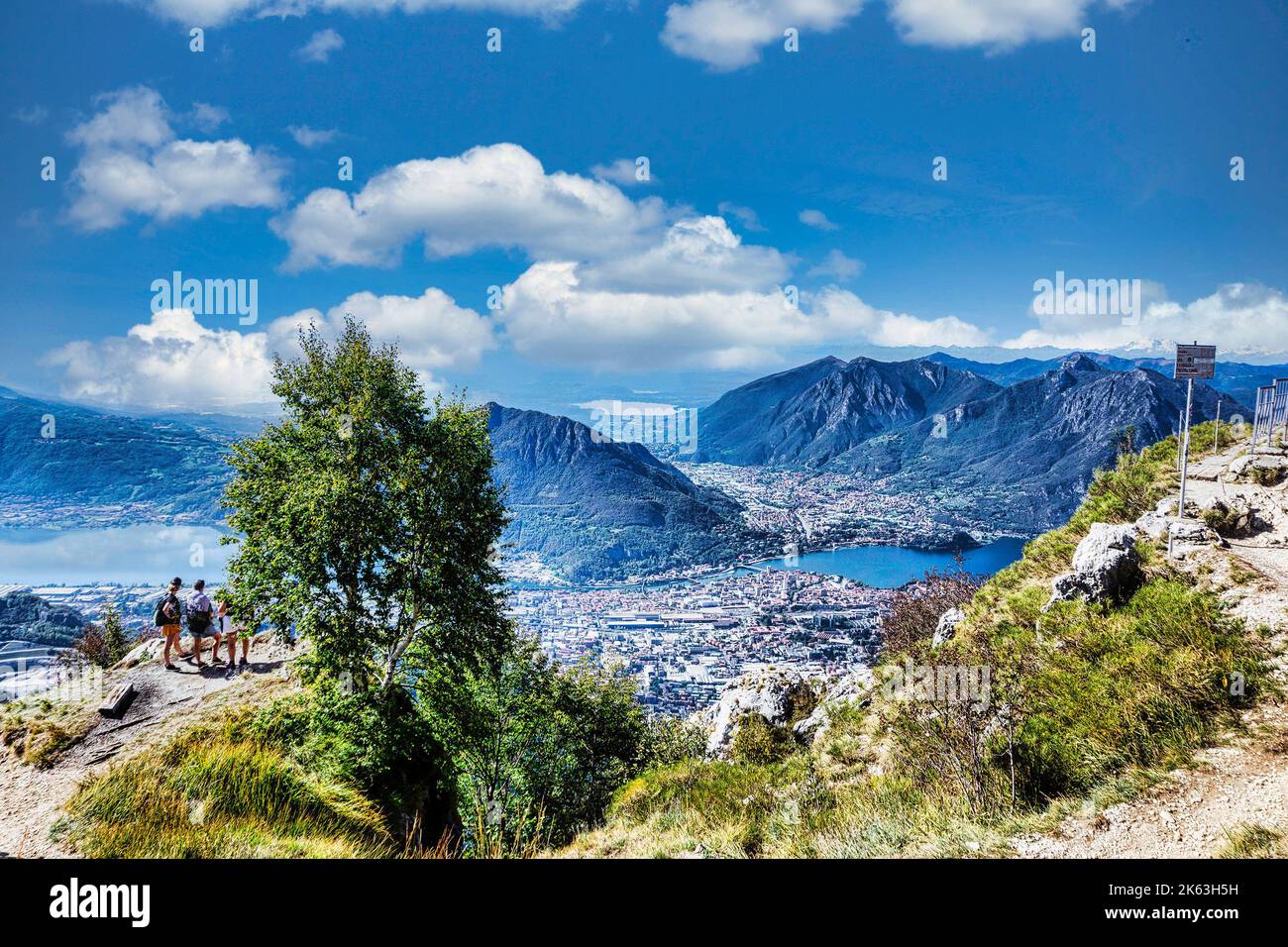 Sightseers at Piani D’erna 1375m above sea level viewing the town of ...